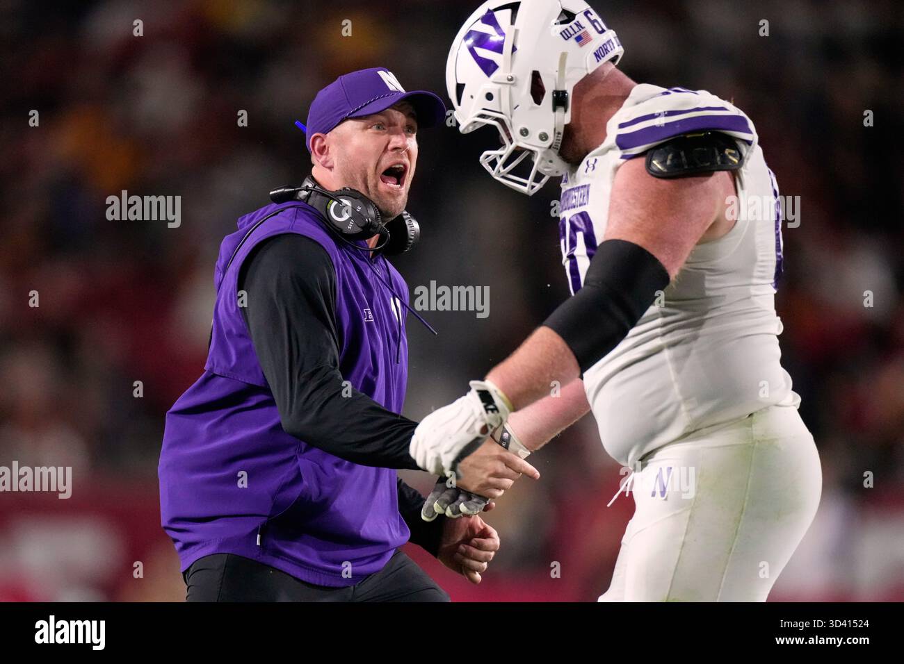 Northwestern head coach David Braun, left, congratulates offensive ...