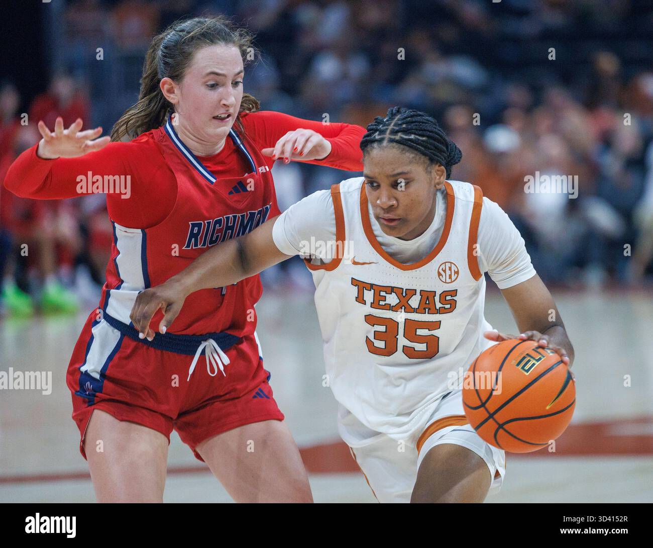 Texas forward Madison Booker drives against Richmond forward Maggie ...