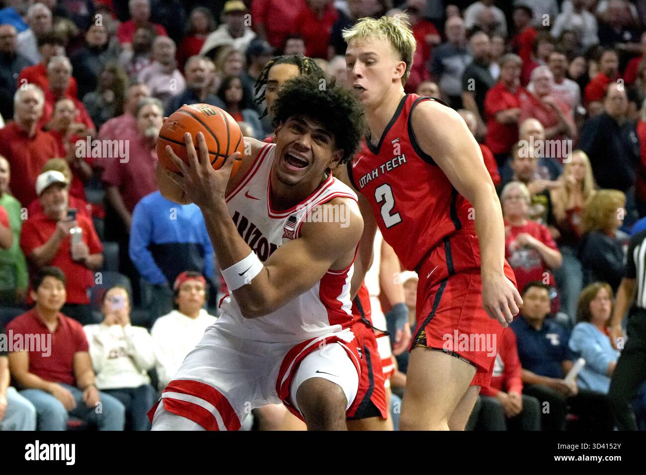 Arizona guard Brayden Burries, left, drives past Utah Tech guard Chance ...