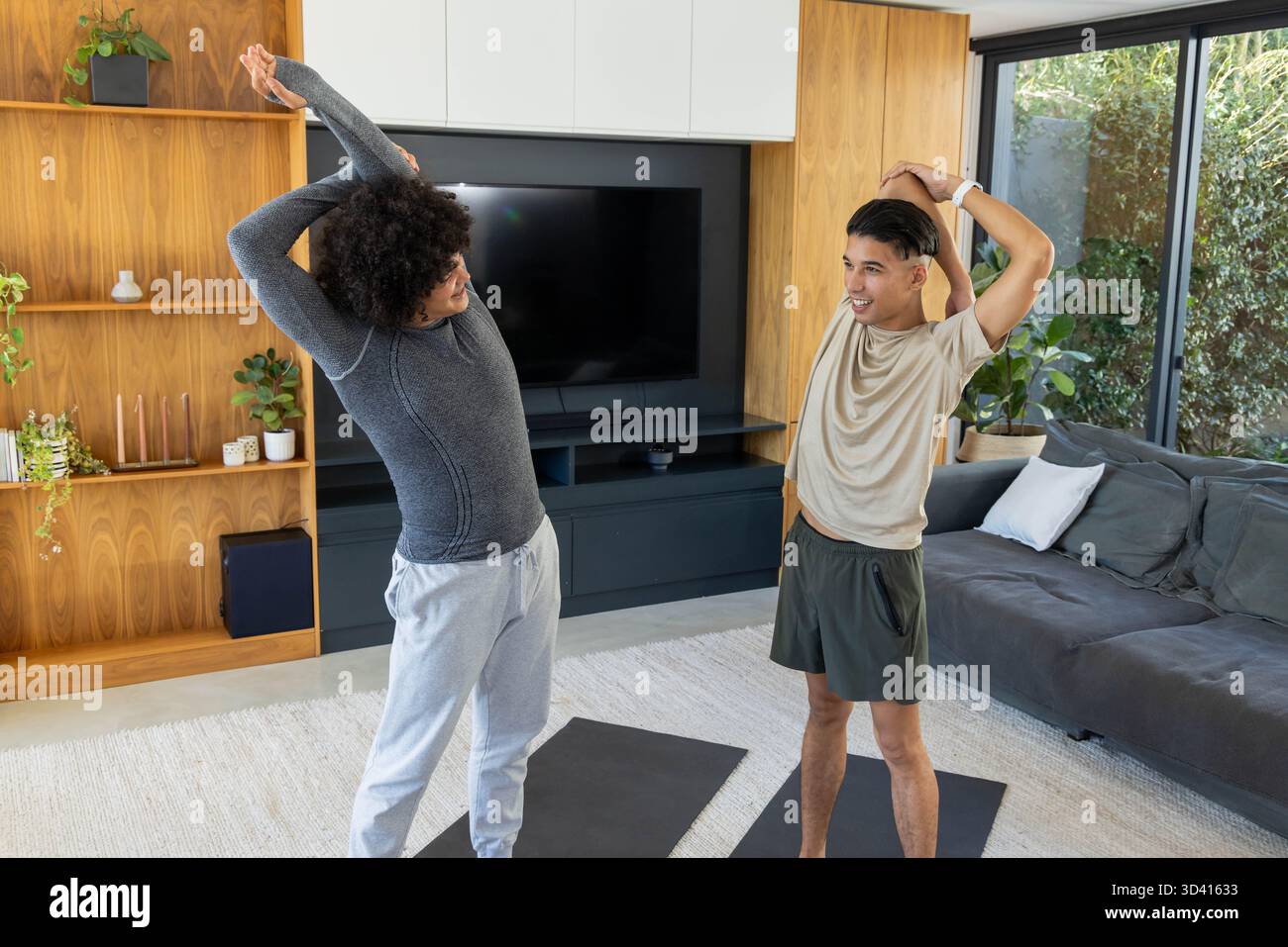 Workout partners stretching overhead in hi-res stock photography and ...