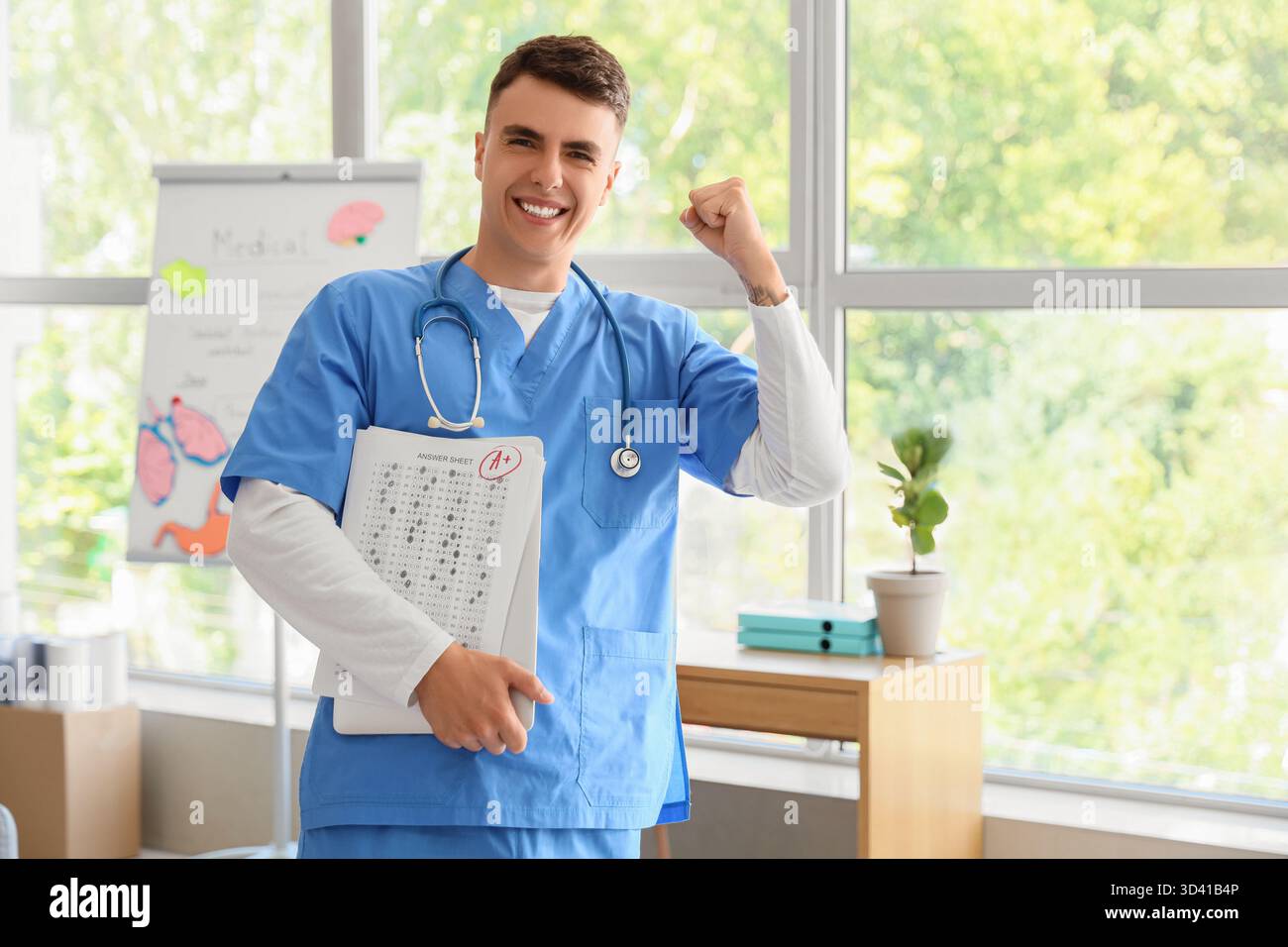 Male medical student celebrating passed exams at home Stock Photo - Alamy