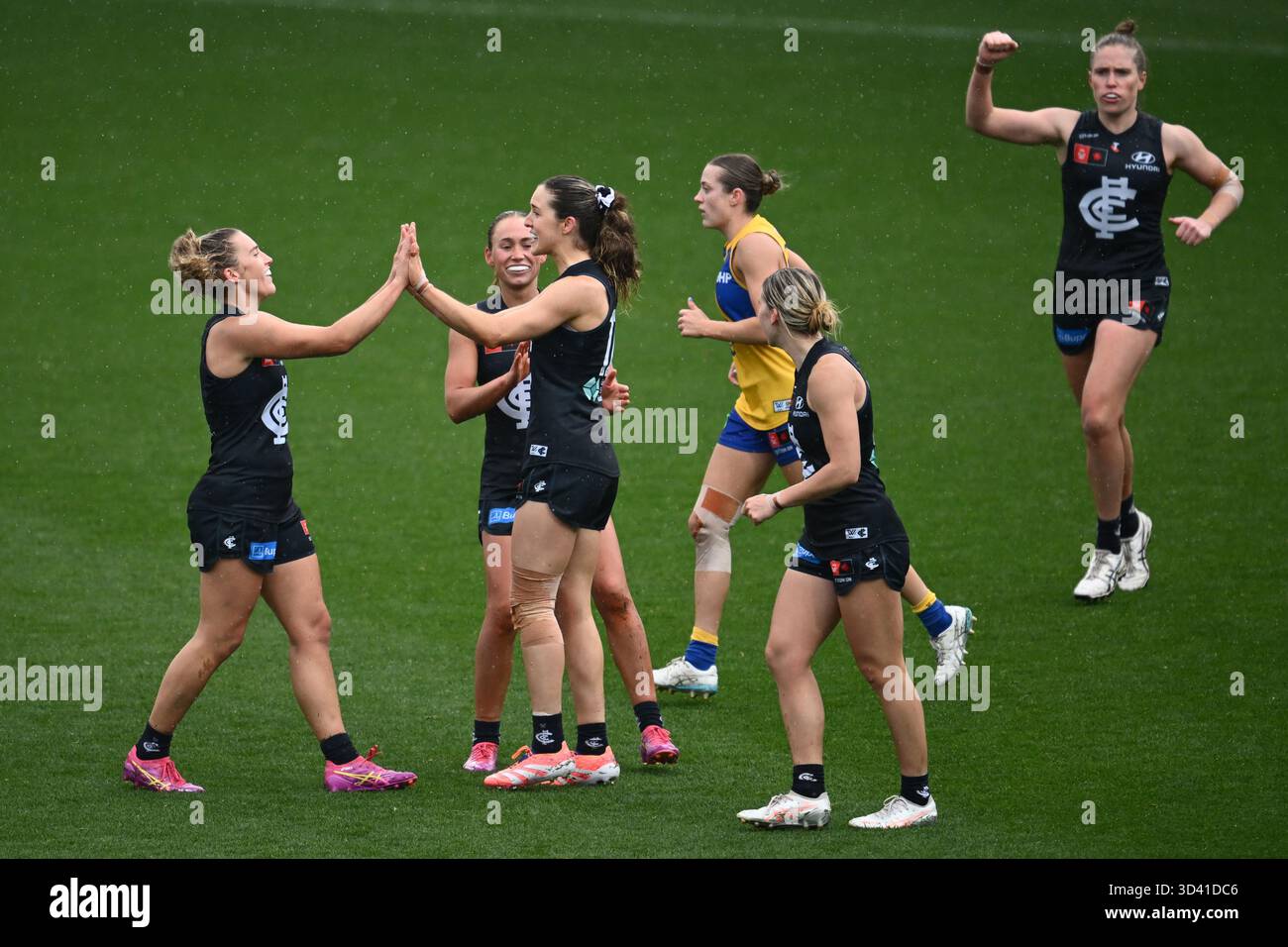 Dayna Finn of Carlton celebrates scoring a goal with teammates during ...