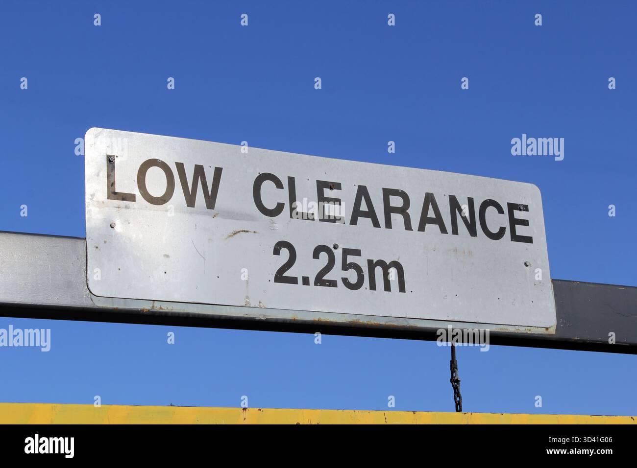 Low Clearance 2.25m height restriction sign against a blue sky ...
