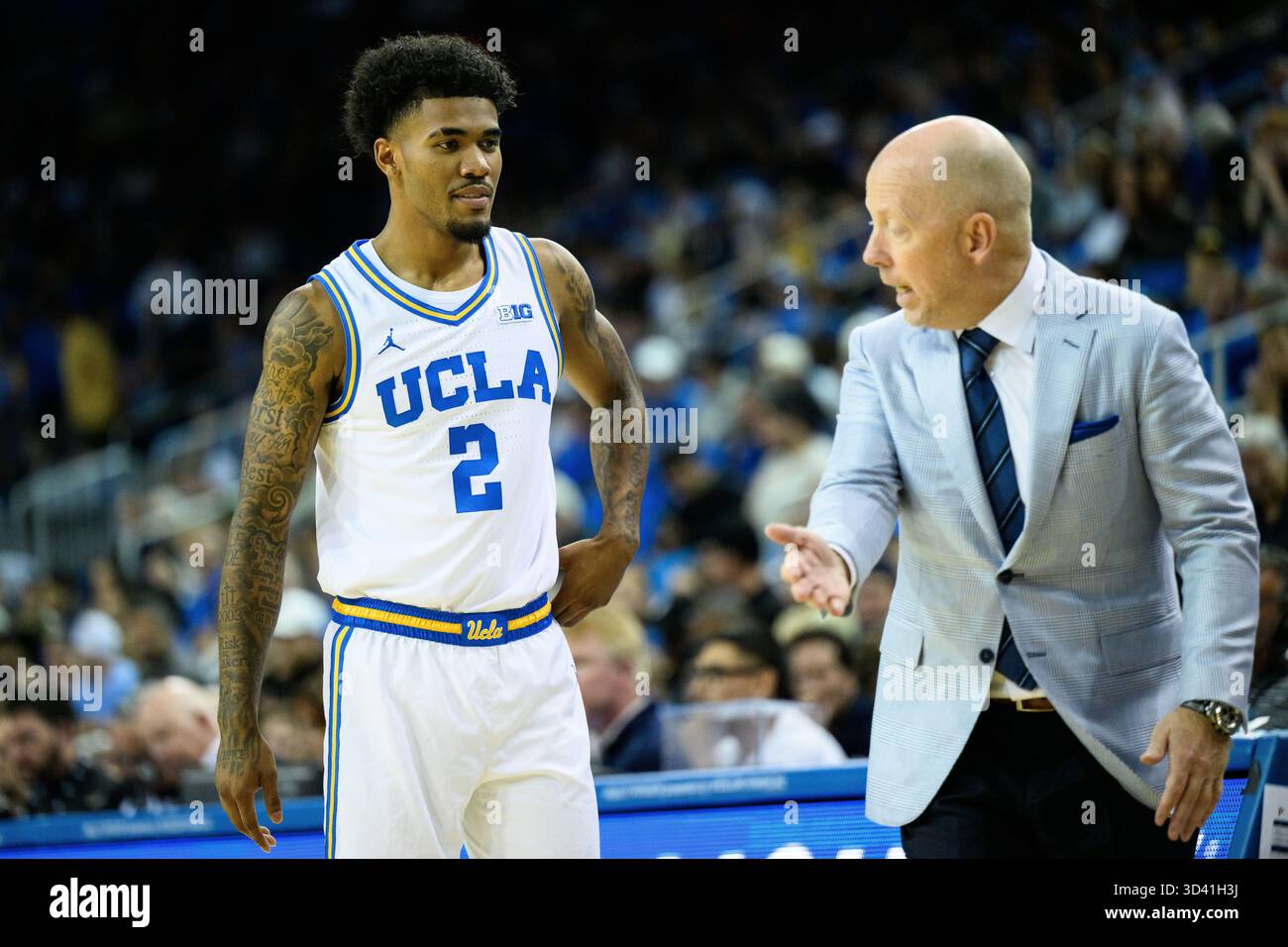 UCLA guard Donovan Dent (2) talks with head coach Mick Cronin during ...