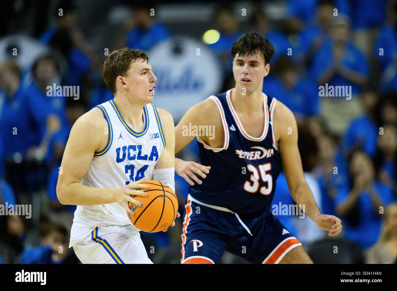 UCLA forward Tyler Bilodeau (34) controls the ball while under pressure ...