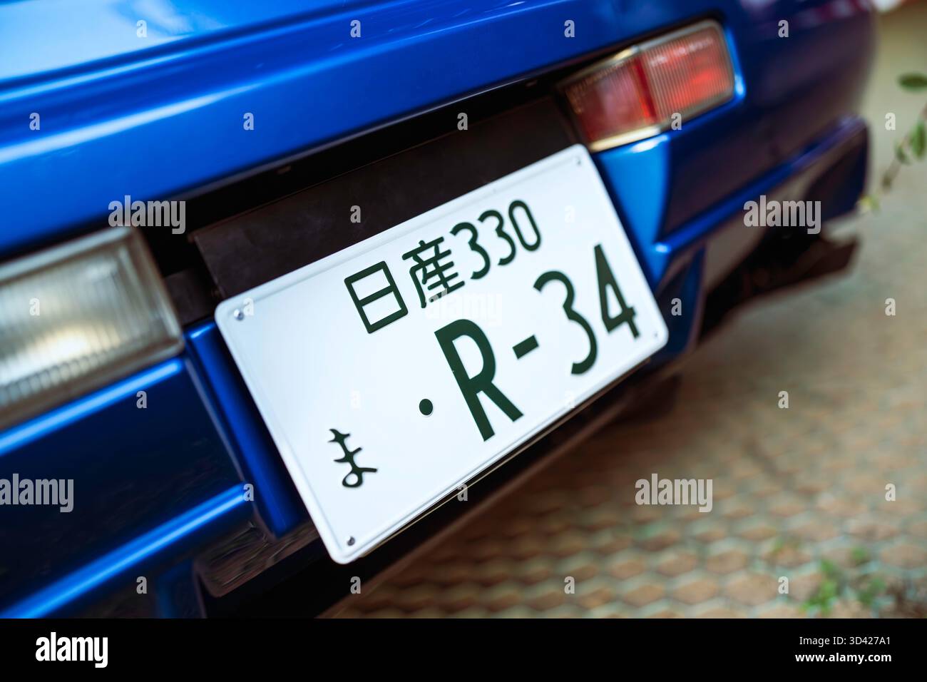 Milan, italy 28 october 2025: blue nissan r34 gt-r rear bumper closeup ...