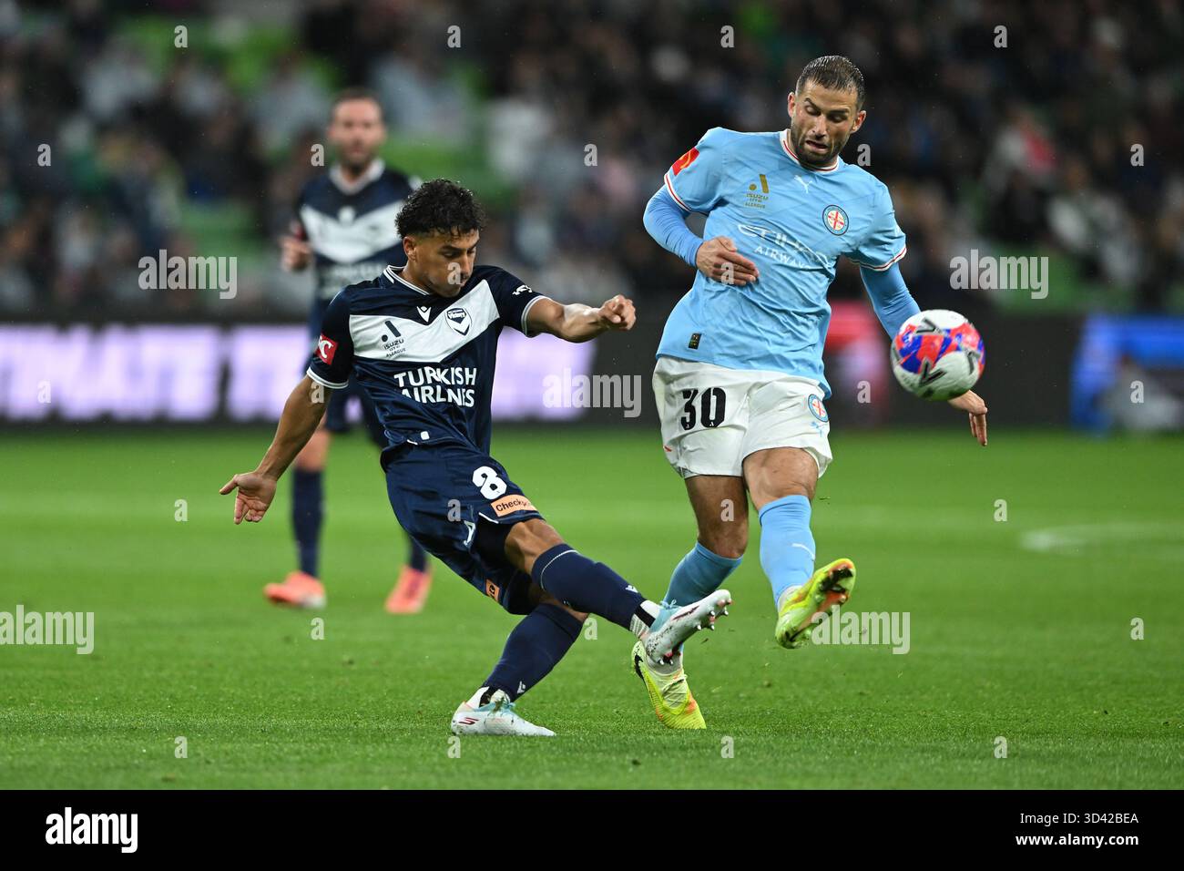 Jordi Valadon of Melbourne Victory (left) kicks the ball during the A ...