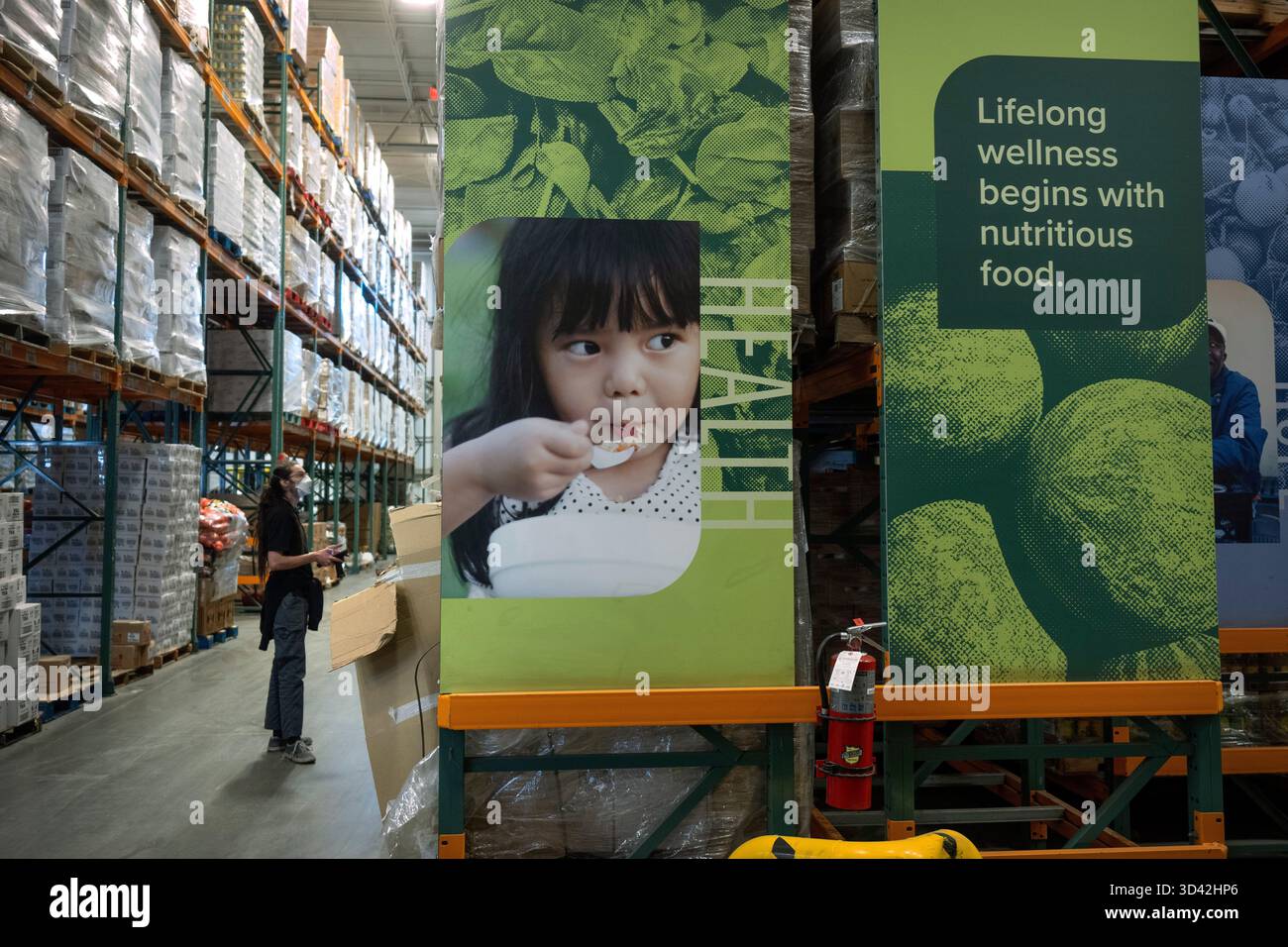 An employee checks inventory at a warehouse of the Capital Area Food ...