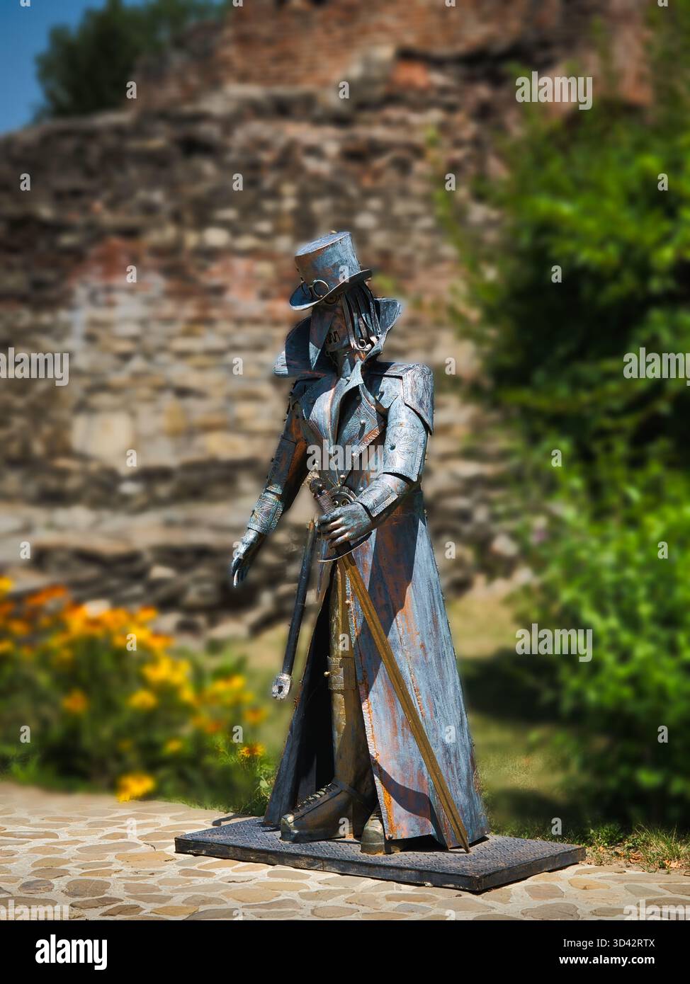 Metal sculpture of a medieval-style guardian holding a sword, displayed ...