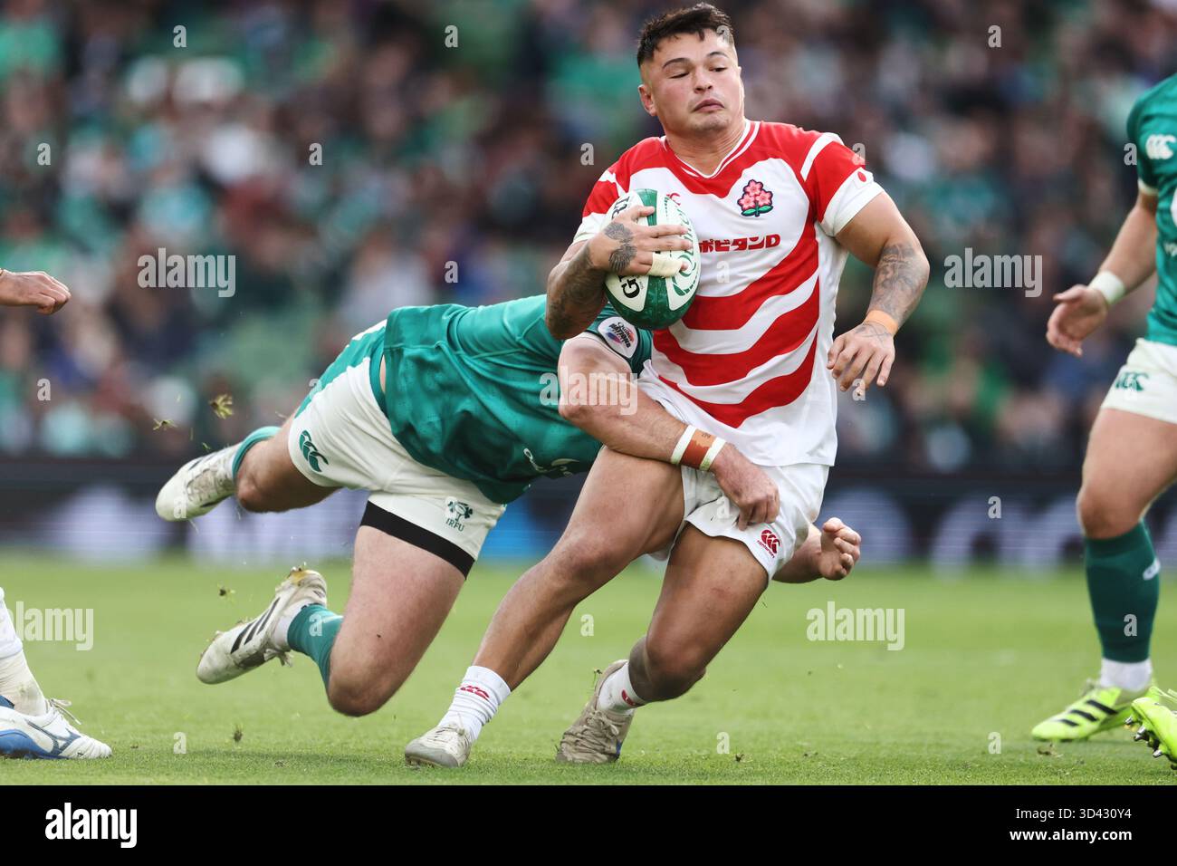 Japan's Charlie Lawrence is tackled by Ireland's Nick Timoney during ...