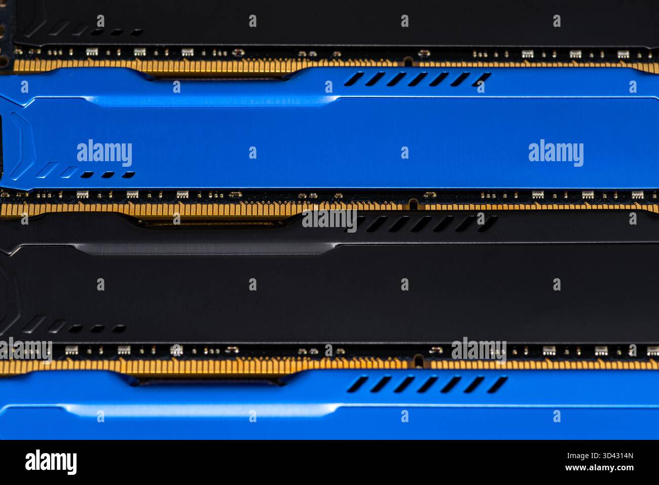 Four DDR memory chips in different colors lying on a blue printed ...