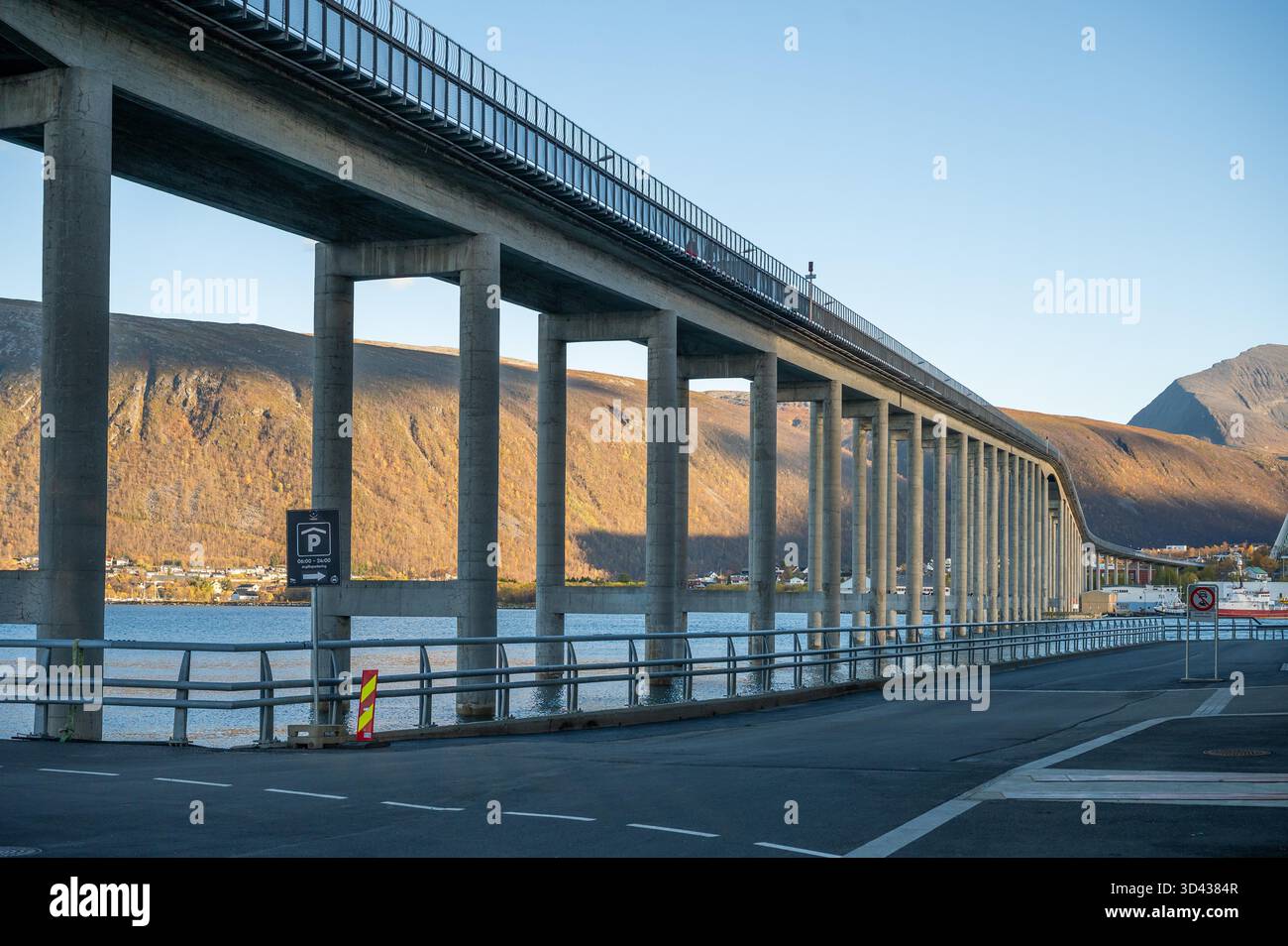 Tromsobrua Bridge, long bridge spans over a body of water, with ...