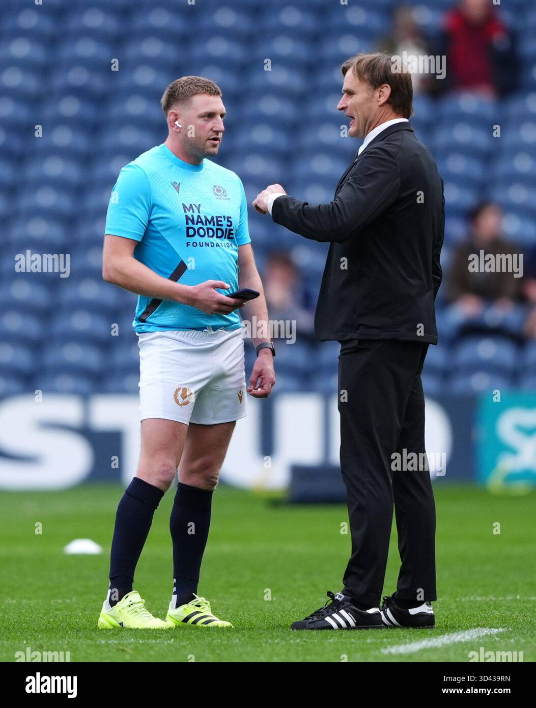 New Zealand head coach Scott Robertson (left) speaks to Scotland's Finn ...