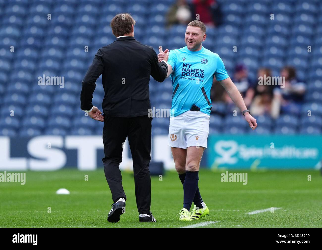 New Zealand head coach Scott Robertson (left) speaks to Scotland's Finn ...