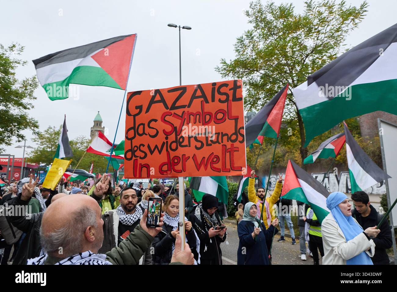 08 November 2025, Hamburg: A participant in a rally against the ...