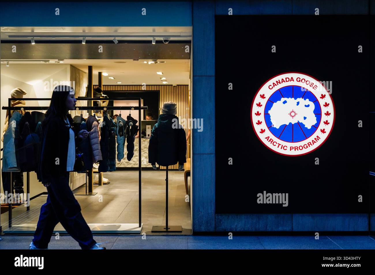 A woman walks pass the Canada Goose store on November 8, 2025 in Hong ...