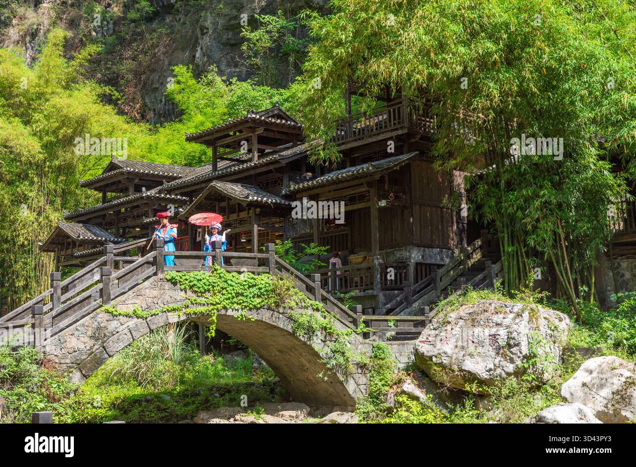 Chinese couple on a bridge on front of Traditional Chinese fisherman's ...