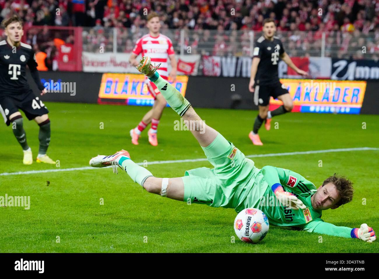 Union's goalkeeper Frederik Ronnow jumps for a ball nexto to Bayern's Lennart Karl during the ...