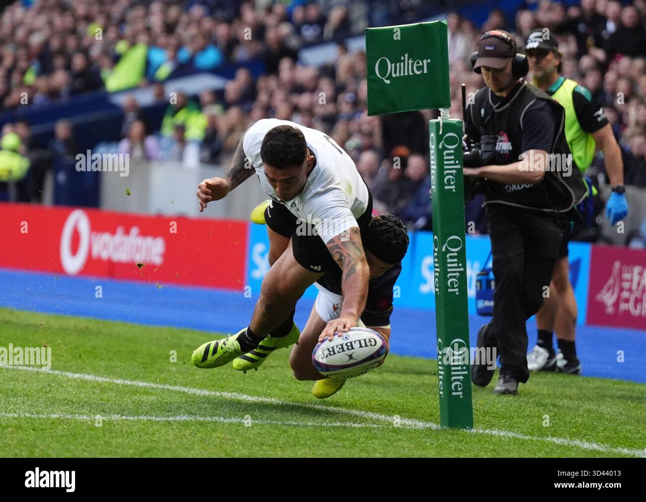 New Zealand's Codie Taylor is challenged by Scotland's Darcy Graham as ...