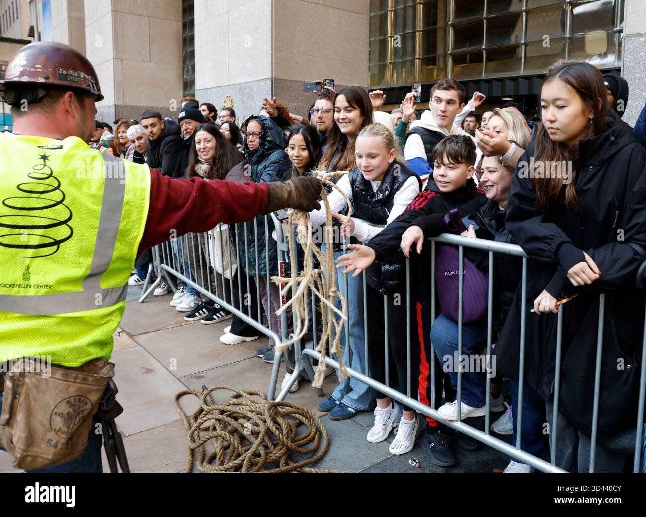Workers pass out rope and pieces fallen branches as they prepare for a ...