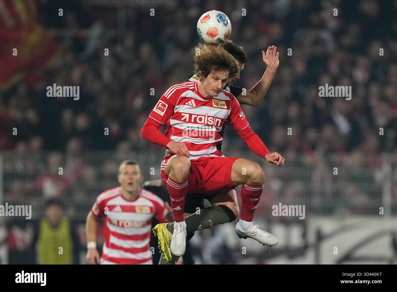 Union's Alex Kral, foreground, and Bayern's Joshua Kimmich challenge ...