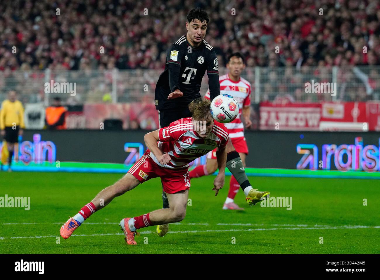 Union's Andras Schaefer, foreground, heads the ball in front of Bayern ...