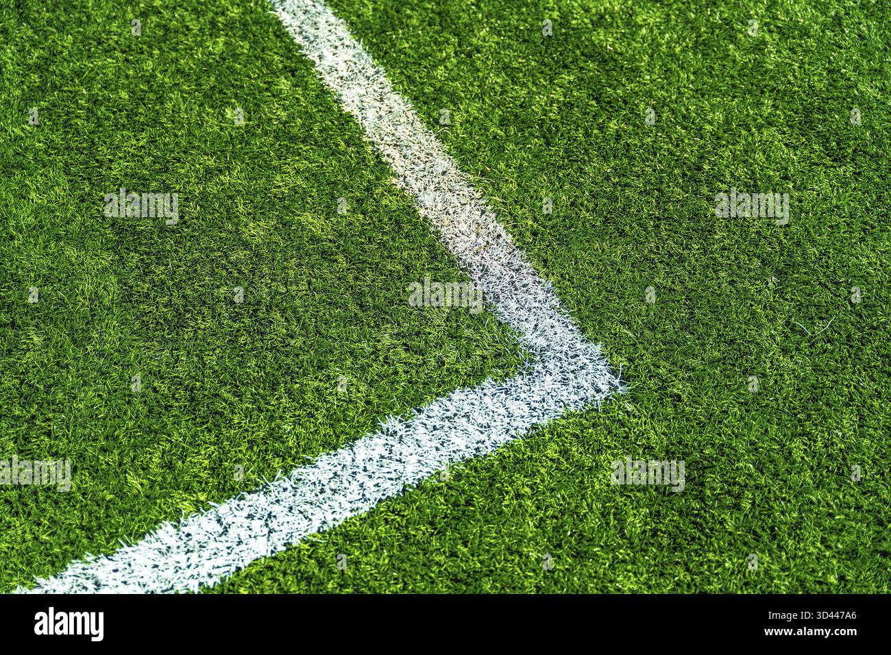 Green artificial turf creating a textured background with a white ...