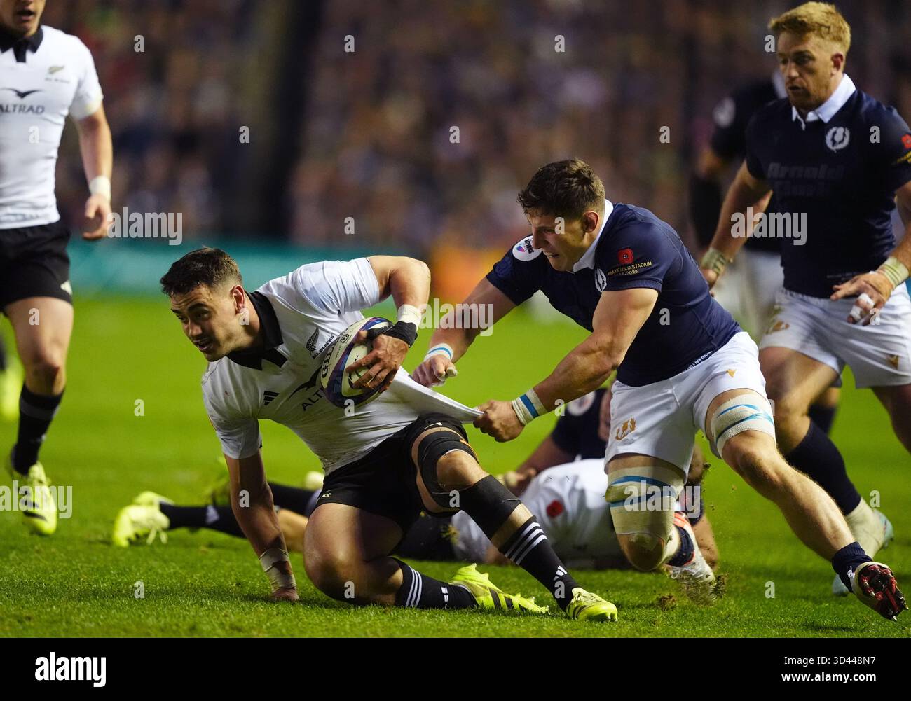 New Zealand's Will Jordan (left) and Scotland's Rory Darge in action ...