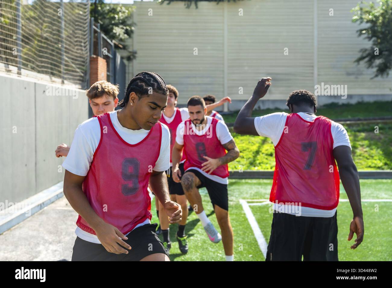 Group of diverse male soccer players engaging in intense drills and ...