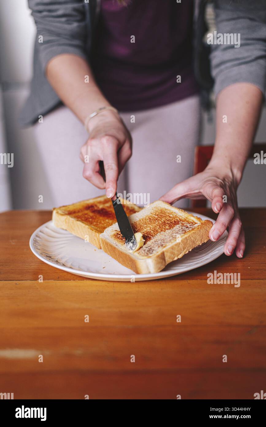Hands spreading butter on hi-res stock photography and images - Alamy