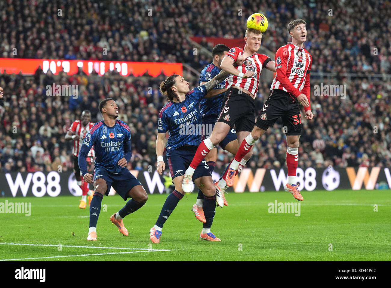 Sunderland's Daniel Ballard heads the ball from pressure during the ...