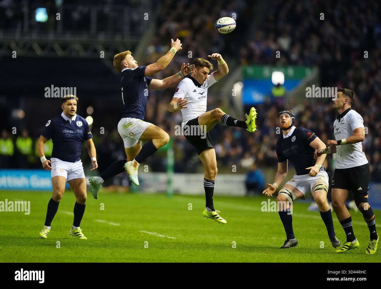 Scotland's Kyle Steyn (left) and New Zealand's Beauden Barrett in ...