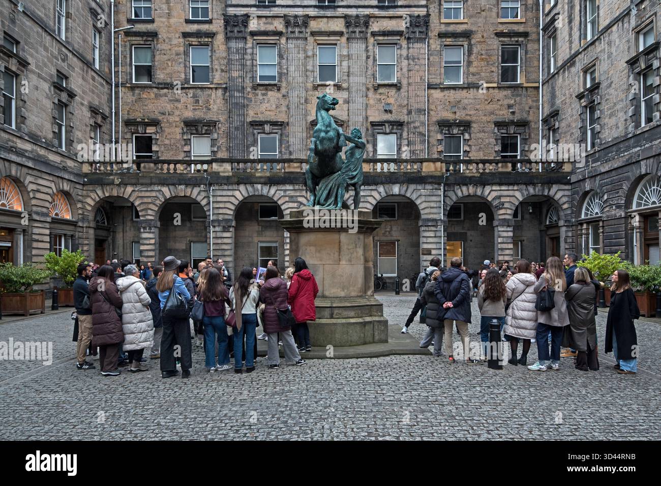 Walking tours standing by the statue of Alexander the Great and ...