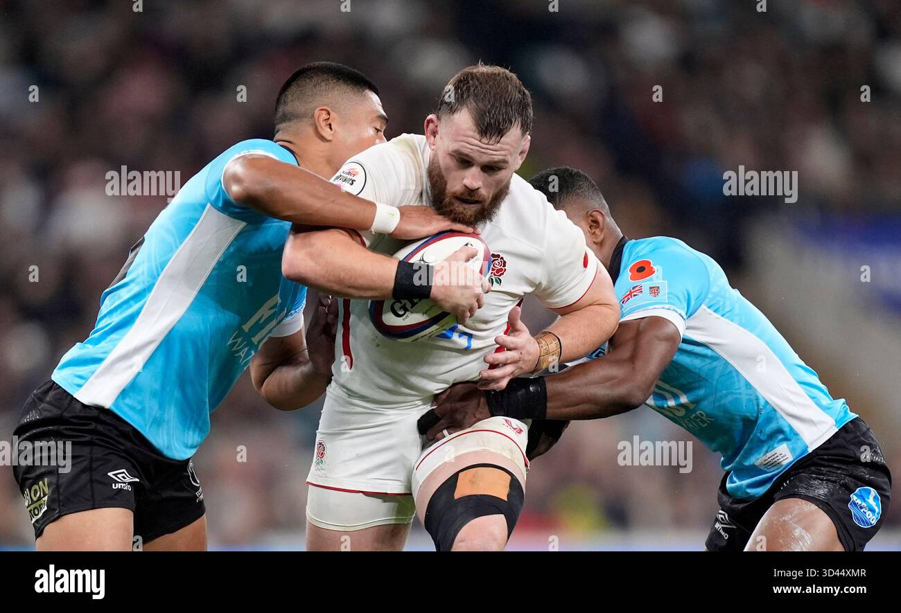 England's Luke Cowan-Dickie (centre) is tackled by Fiji's Salesi Rayasi ...