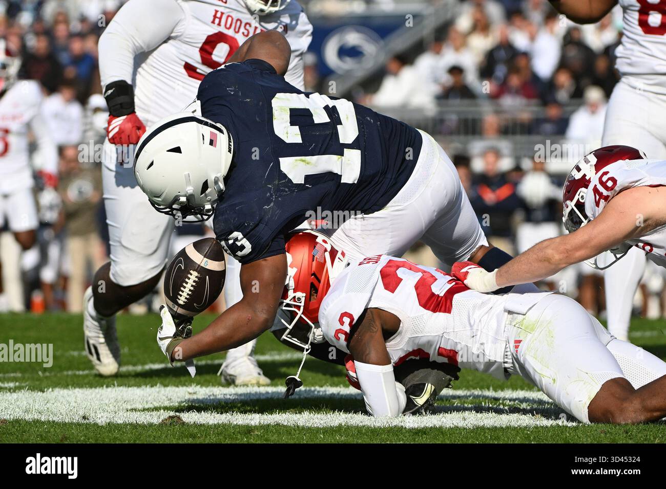 Penn State running back Kaytron Allen (13) fumbles while being tackled ...