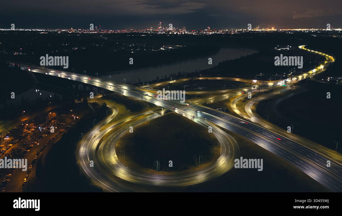 Drone view of bright illuminated highway intersection forming circular ...