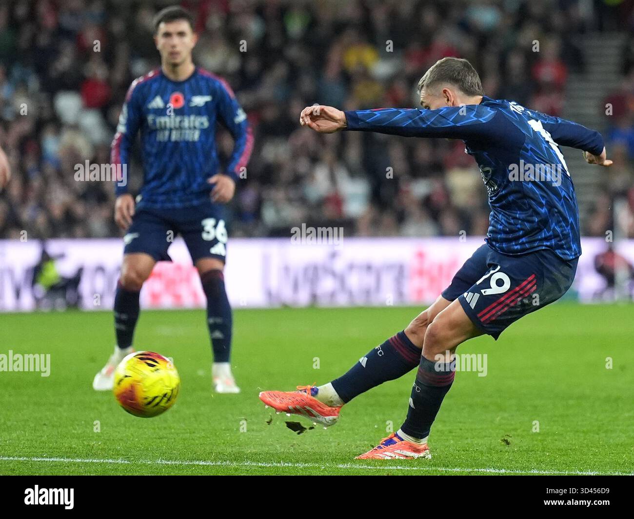 Arsenal's Leandro Trossard (right) scores their side's second goal of ...