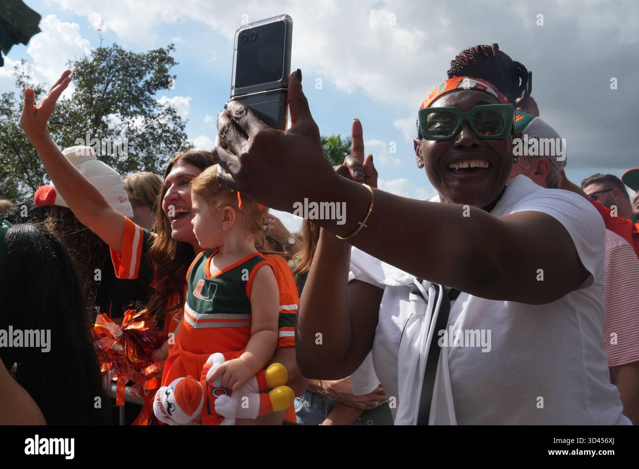Miami fans cheer the team as it arrives to play in an NCAA college ...