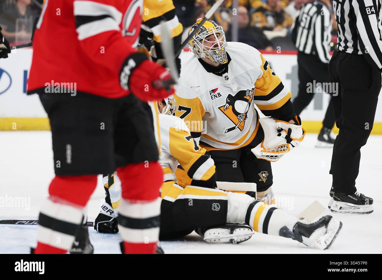 Pittsburgh Penguins goaltender Arturs Silovs, center, stands up after a ...