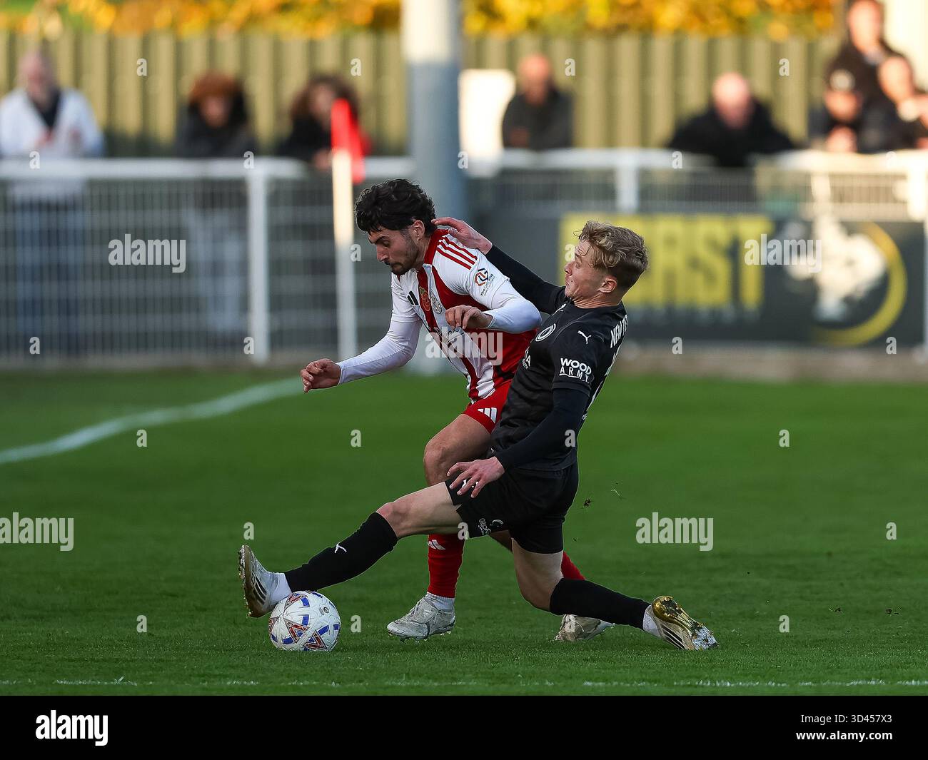 BRACKLEY, ENGLAND - NOVEMBER 8: Joe Newton of Boreham Wood tackles ...