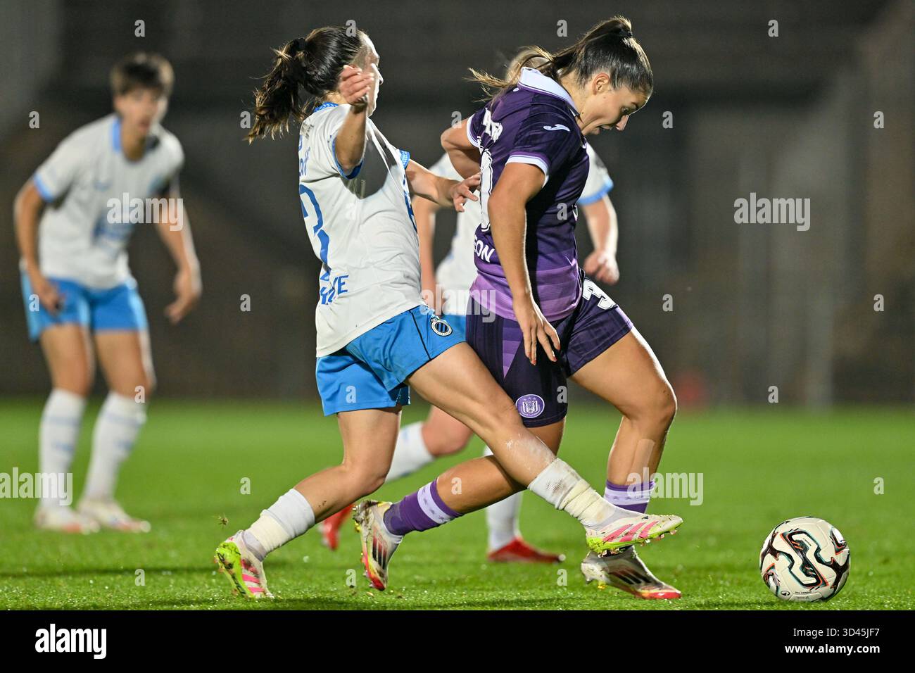 Angel Kerkhove (13) of Brugge pictured fighting for the ball with Luna Vanzeir (30) of ...