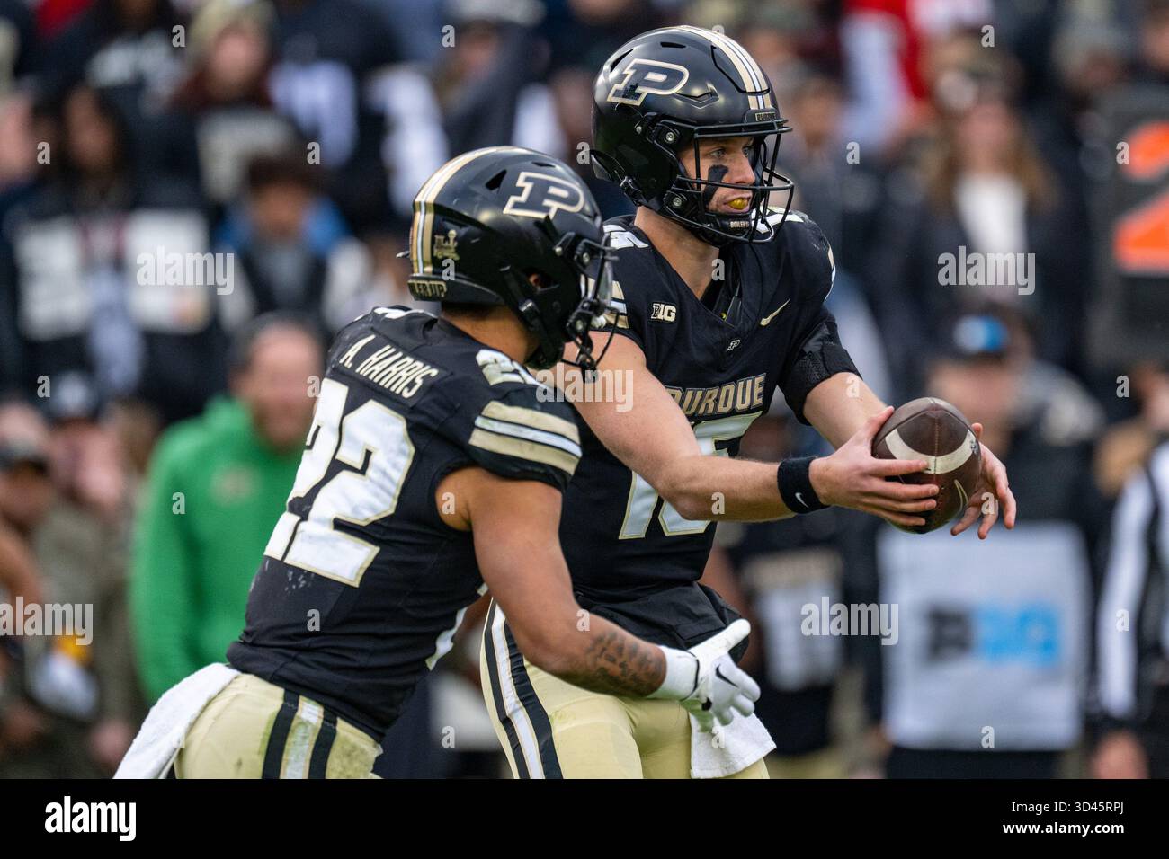 Purdue quarterback Ryan Browne (15) hands off to running back Antonio ...