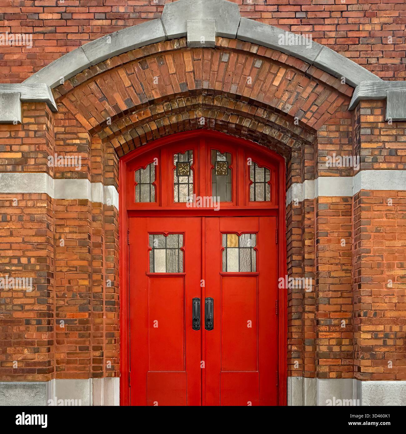 Arched red church doors with stained glass panels and brick detailing ...
