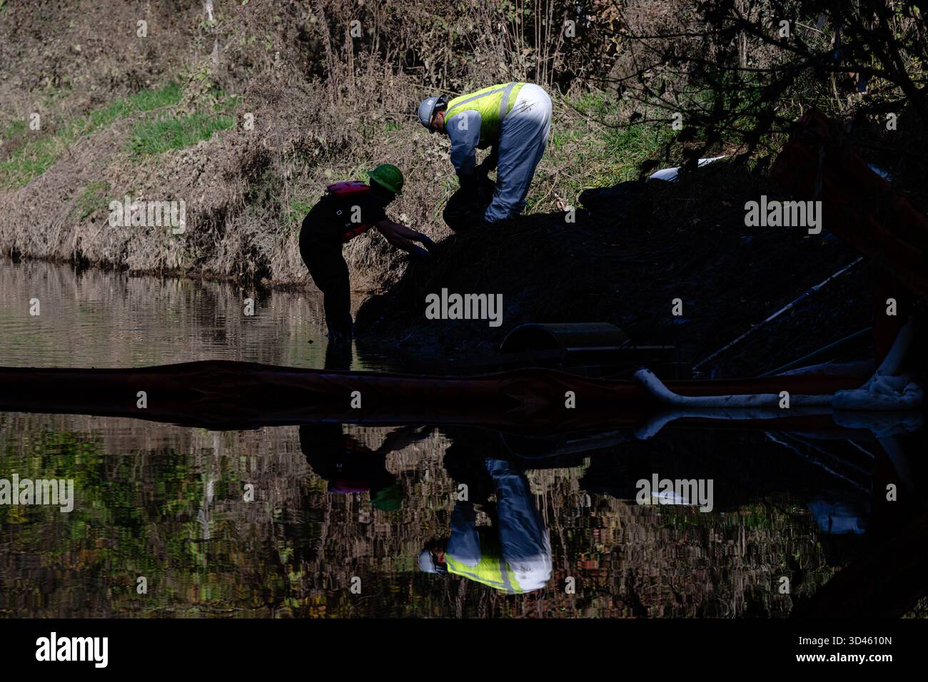 Workers clean oil and sludge runoff from the UPS plane crash from a ...