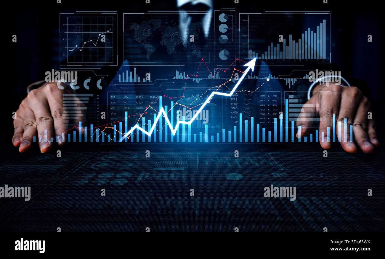A businessman focuses on digital graphs and charts to analyze data ...