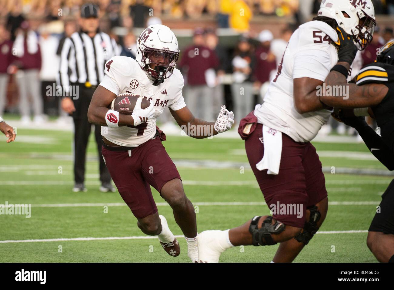 Texas A&M running back Rueben Owens II, left, runs the ball during the ...
