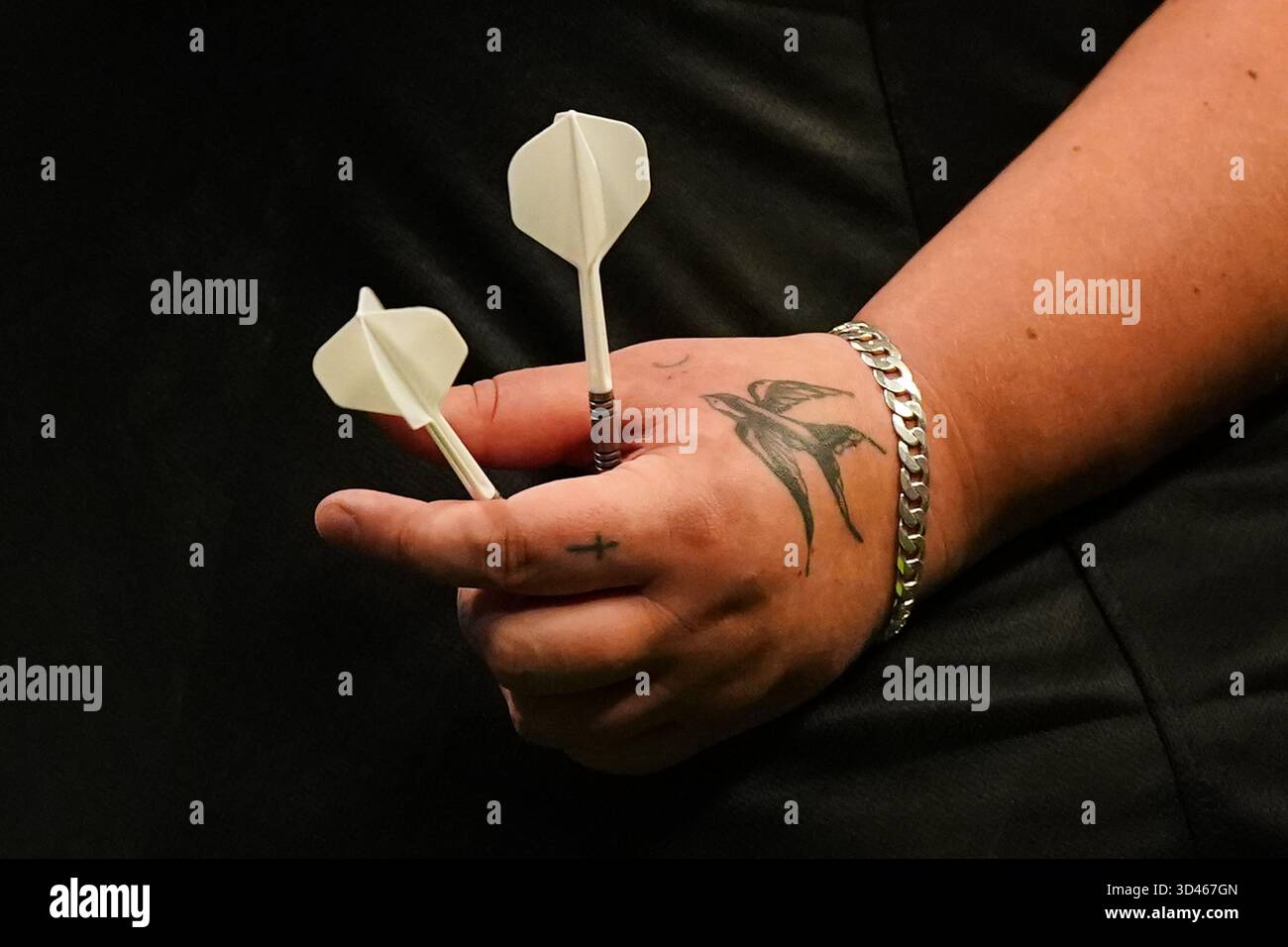 Beau Greaves holds darts during her match against Michael van Gerwen at ...