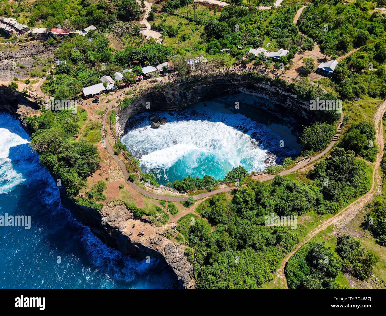 Turquoise ocean waves crashing inside the unique circular rock ...