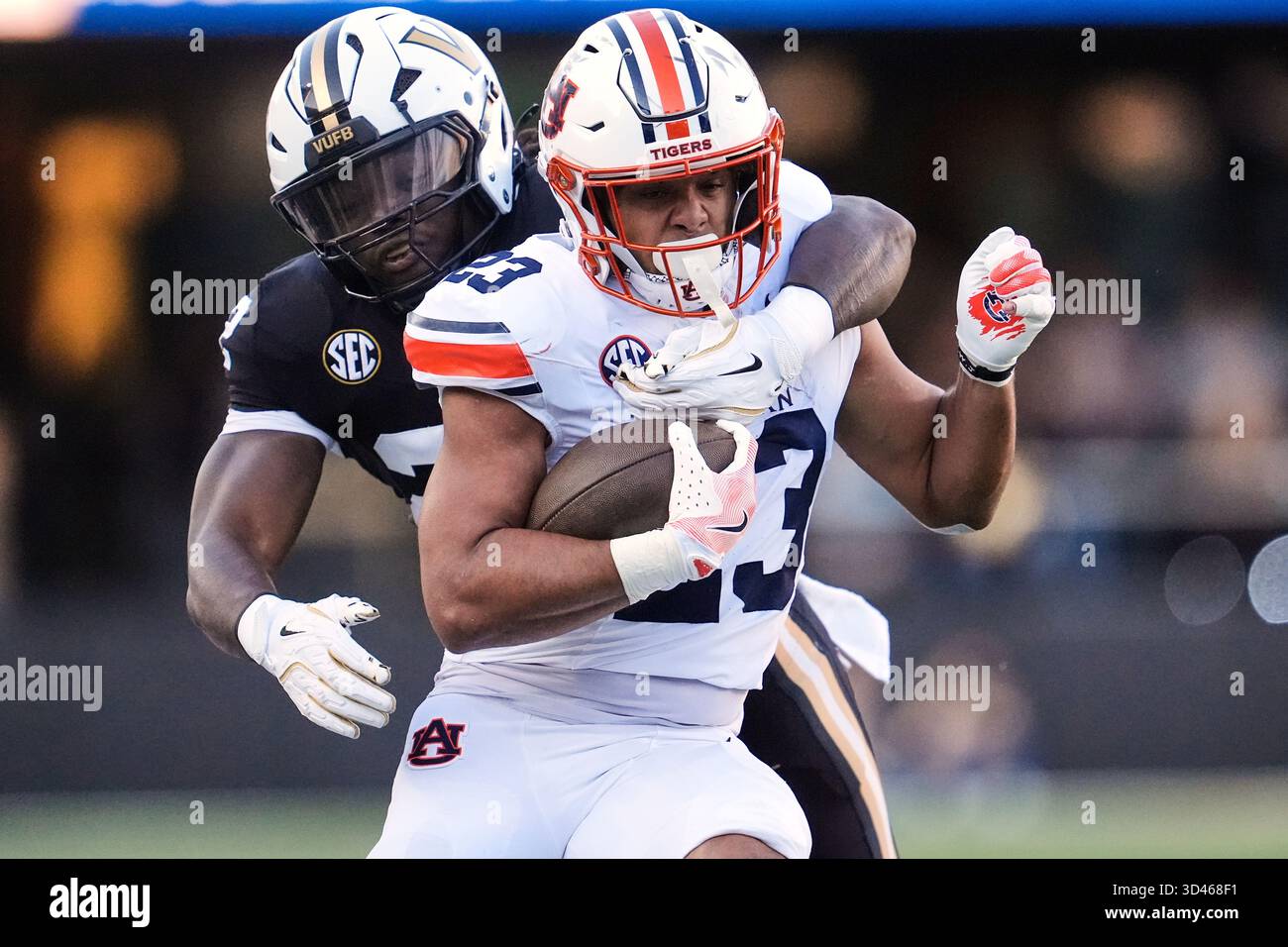 Vanderbilt linebacker Bryce Cowan, left, tackles Auburn running back ...
