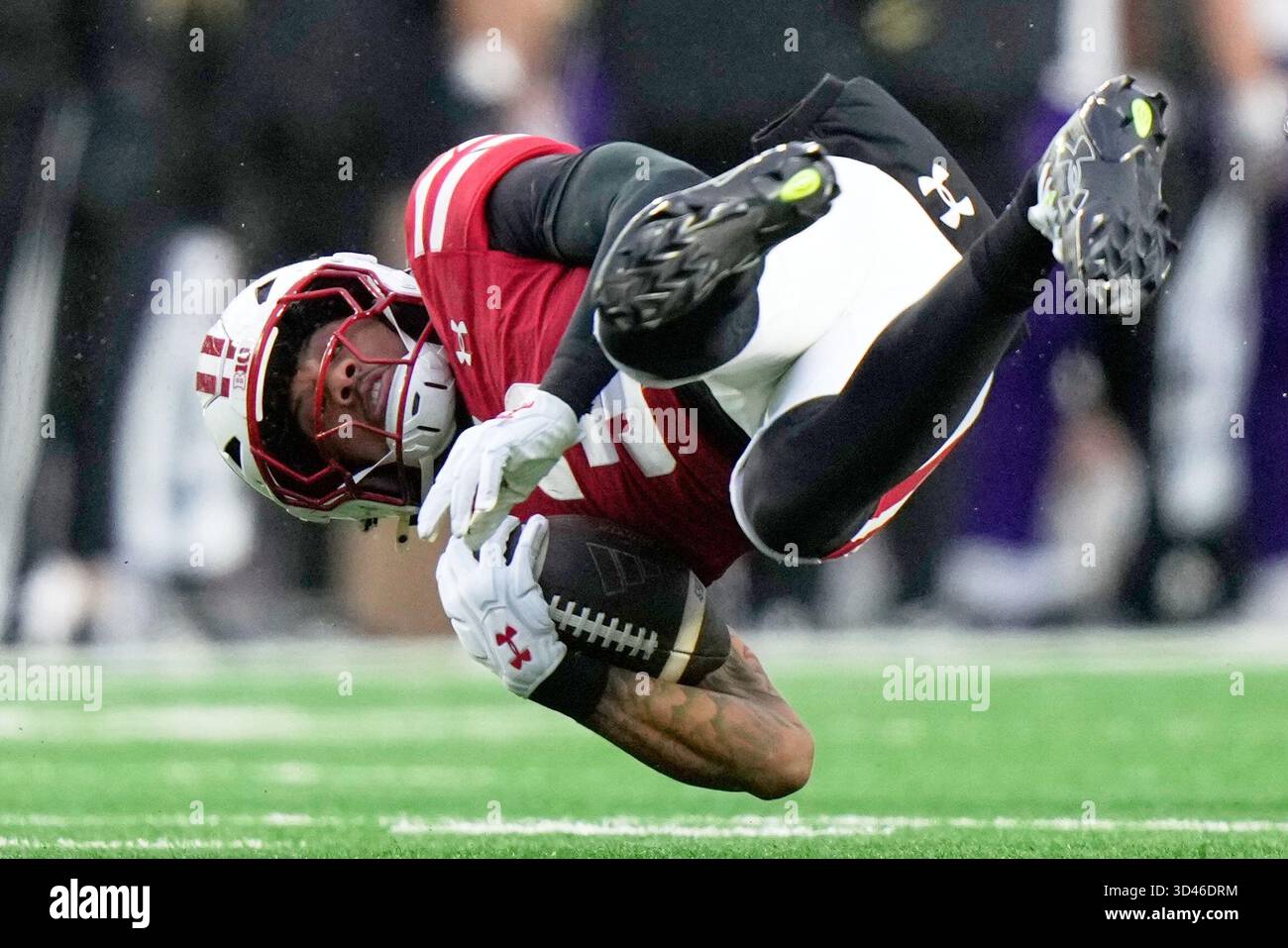 Wisconsin's Tyrell Henry is tripped up on a punt return during the ...